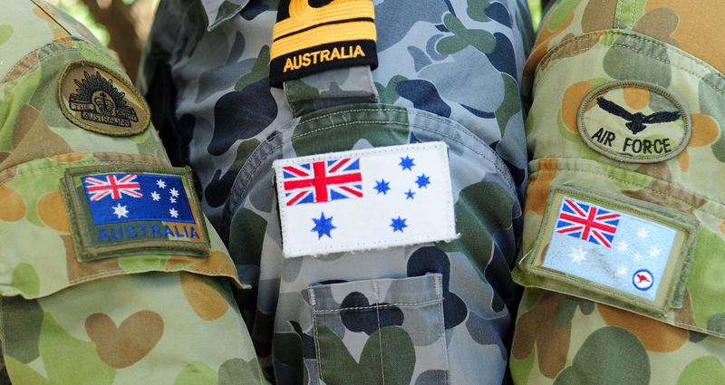 Service members saluting flag